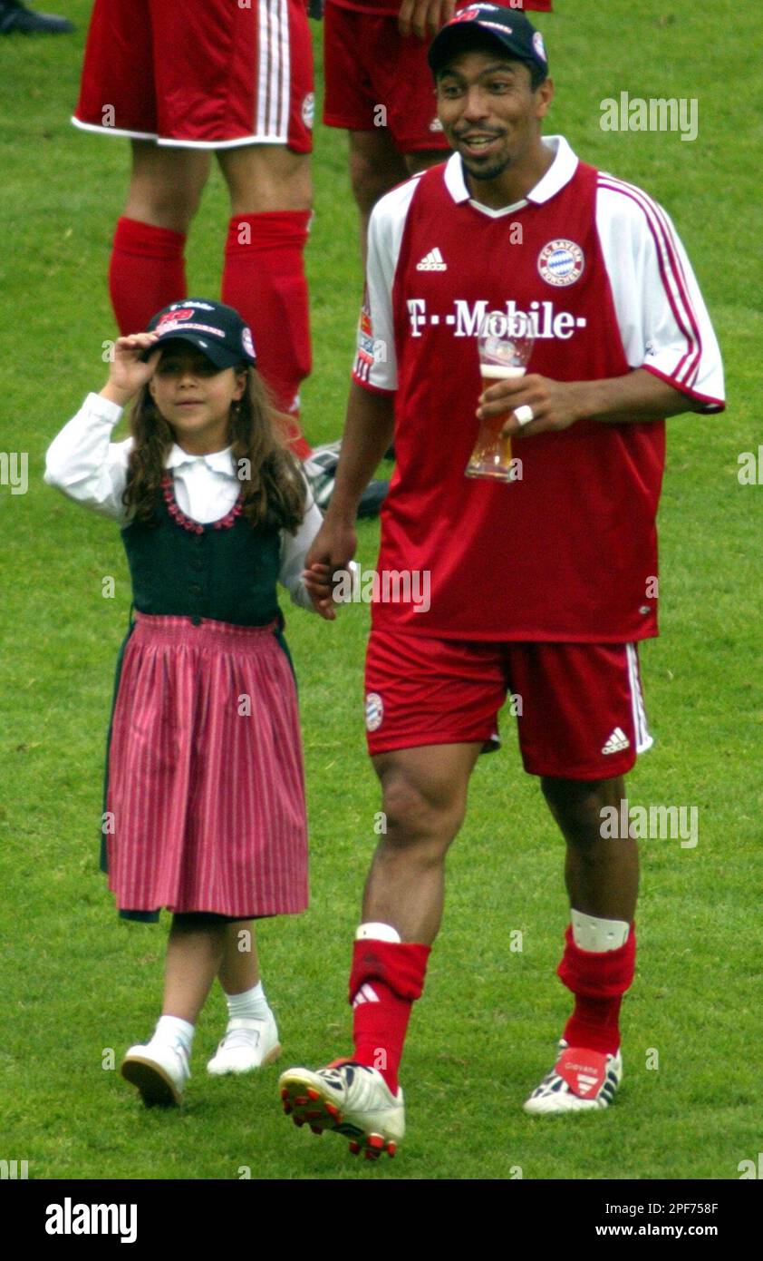 Munich's Brazilian striker Giovane Elber walks with a glass of beer on ...