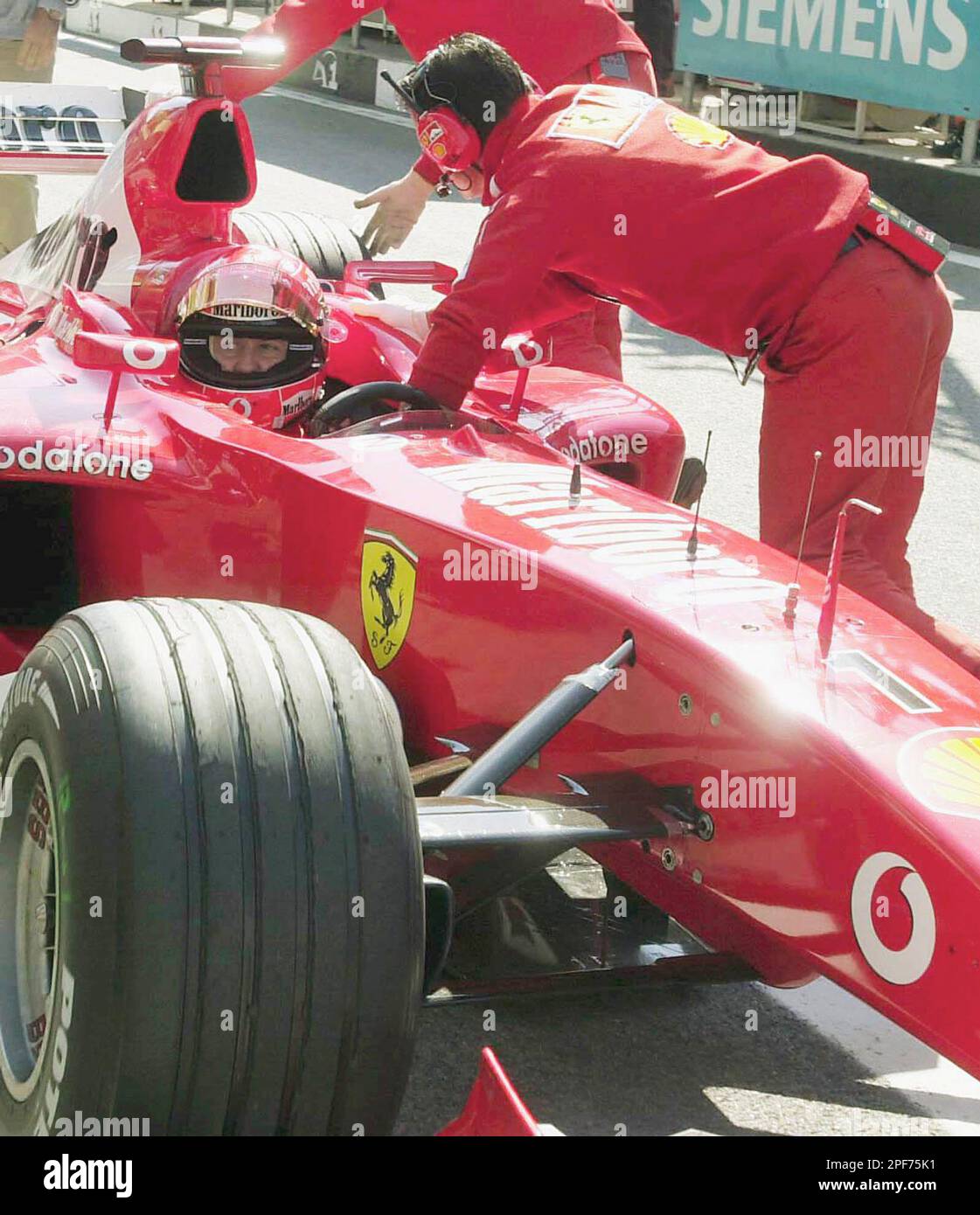 Ferrari technicians check the racing car of Germany's Michael ...