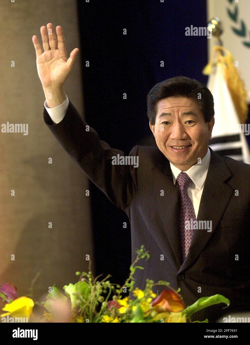 South Korean President Roh Moo-hyun waves to audience members during a ...