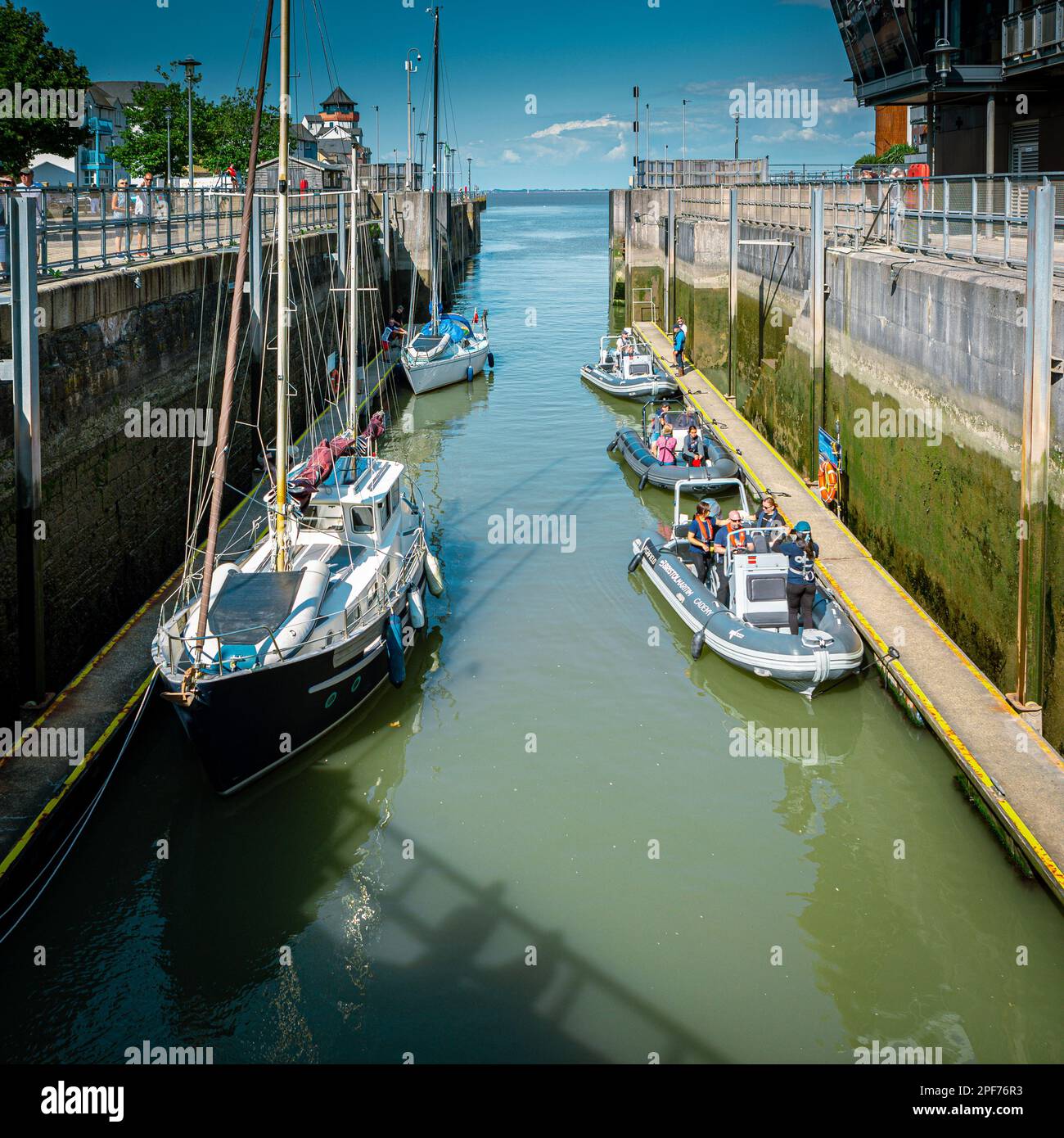 Pleasure boats traversing the lock at Portishead Marina, Somerset, UK ...