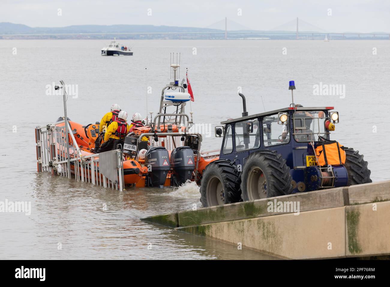 Lifeboat being launched out to sea but a tractor Stock Photo - Alamy