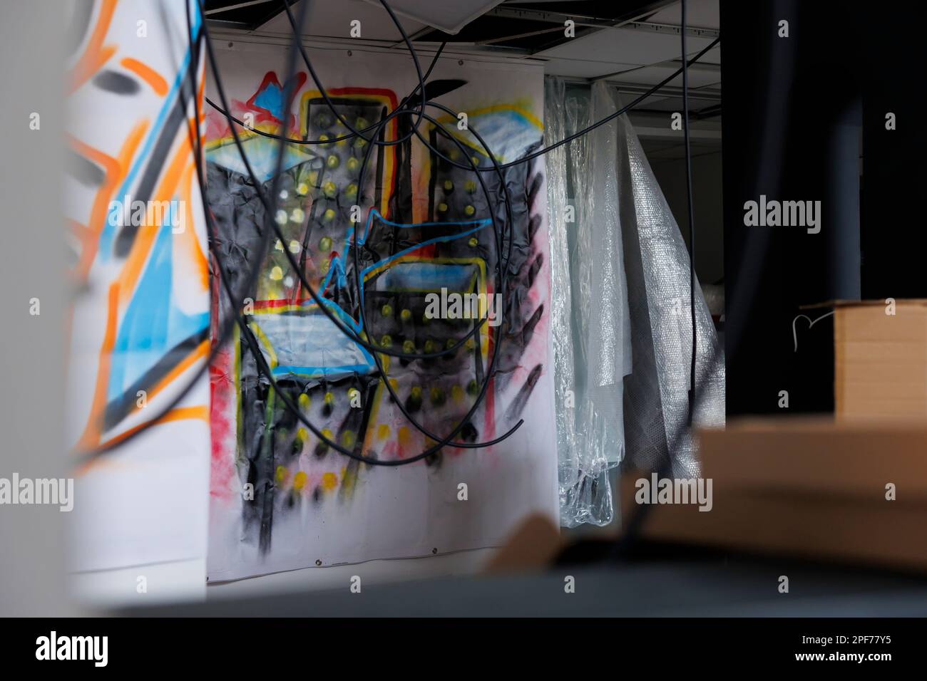 Broken down wall covered in spray paint art, messy structure of damaged ...