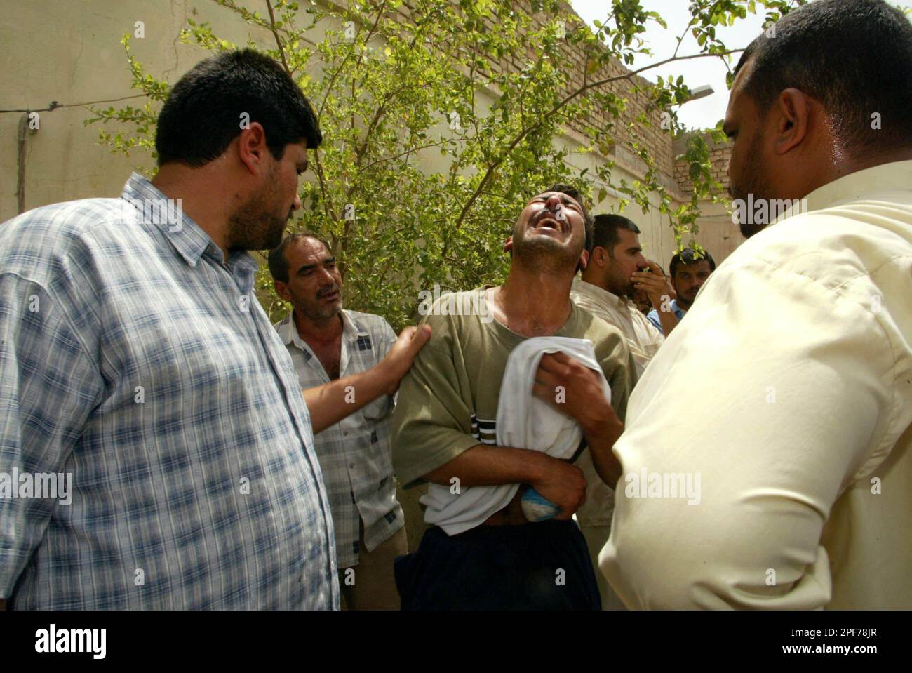 Motaz Jassem al Alvi, 25, cries after having identified his brother ...