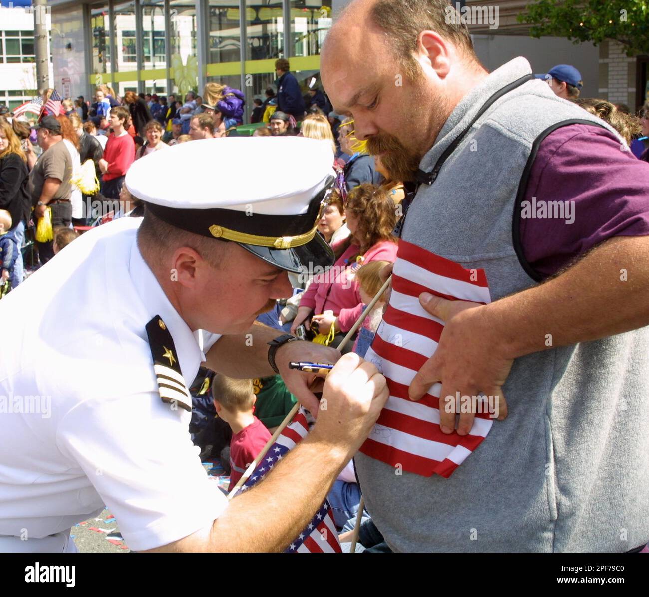 Commander Neil Radford signs an U.S. flag for Edward Morgan, of Everett ...