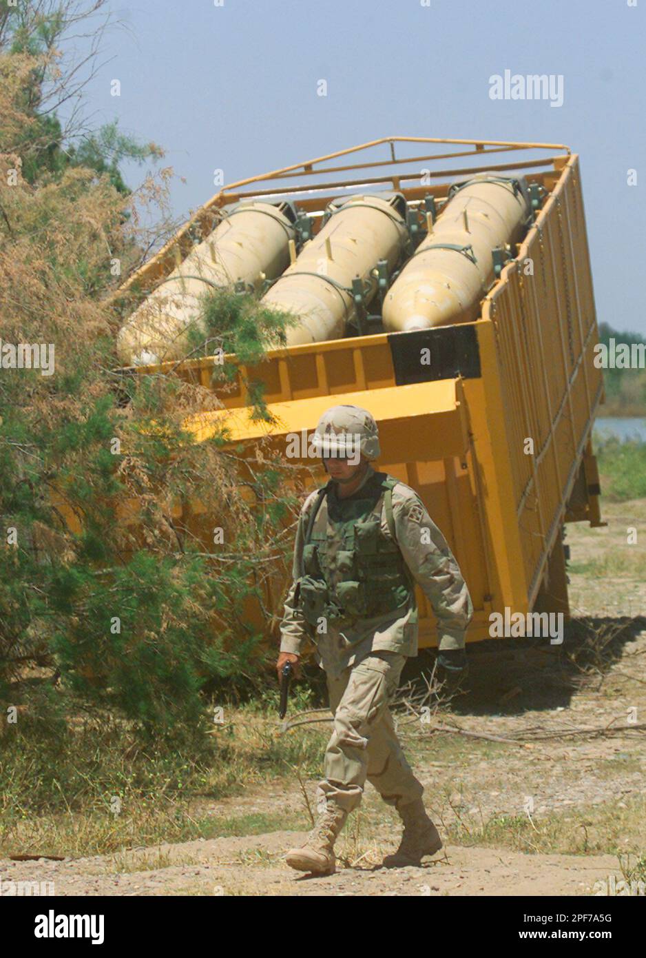 A soldier of the 4th Infantry Division walks by a container loaded with ...