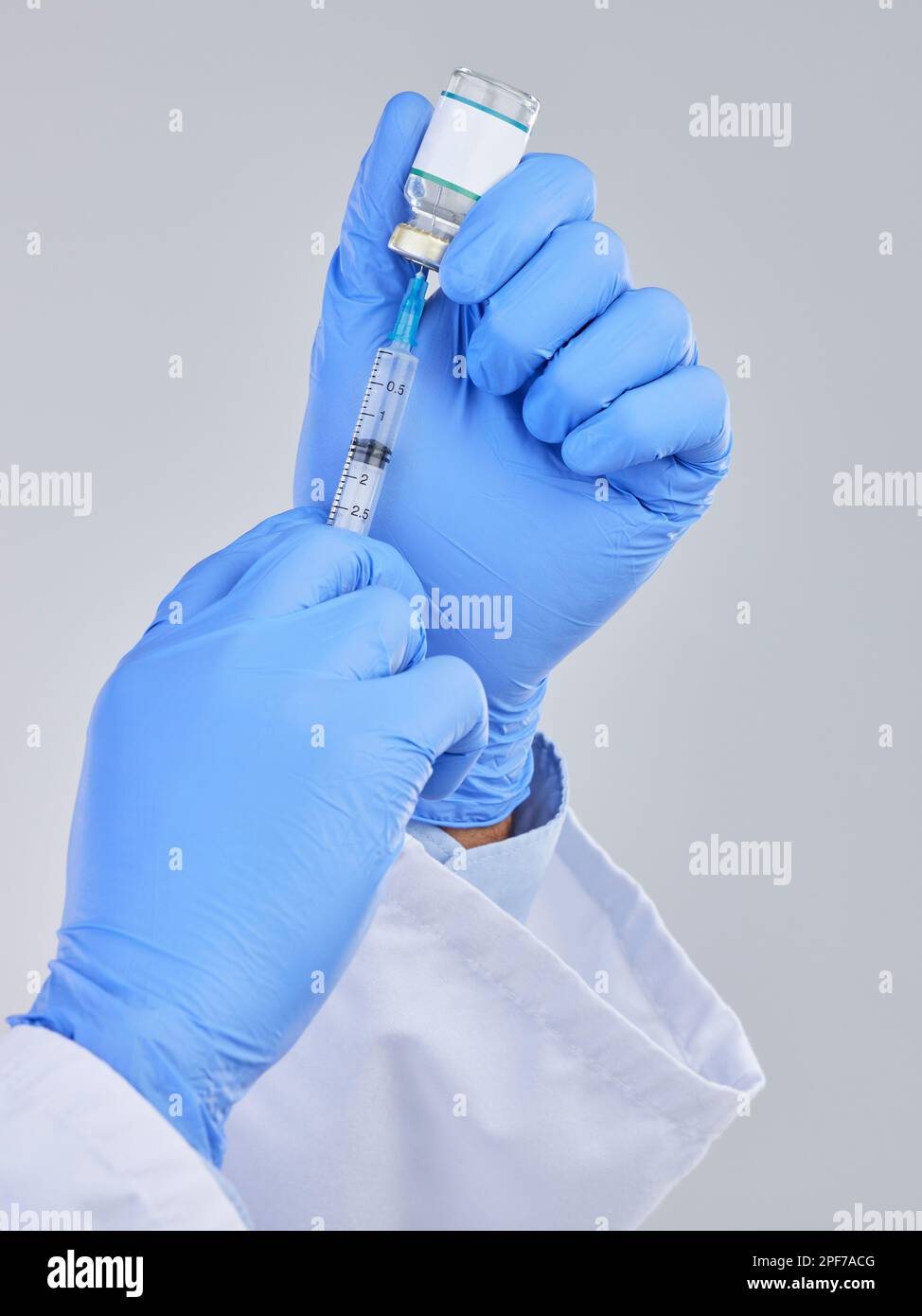 Vaccine vial, needle and doctor hands in studio for safety, healthcare ...