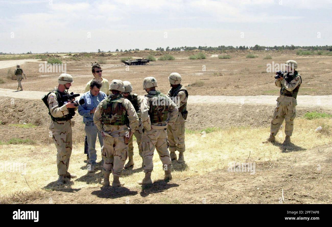 A combat camera team from the 3rd Infantry Division interviews soldiers ...
