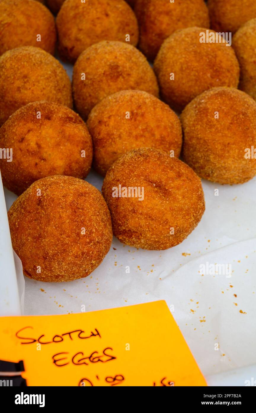 Traditional street food in UK, stuffed fried Scotch eggs with ...