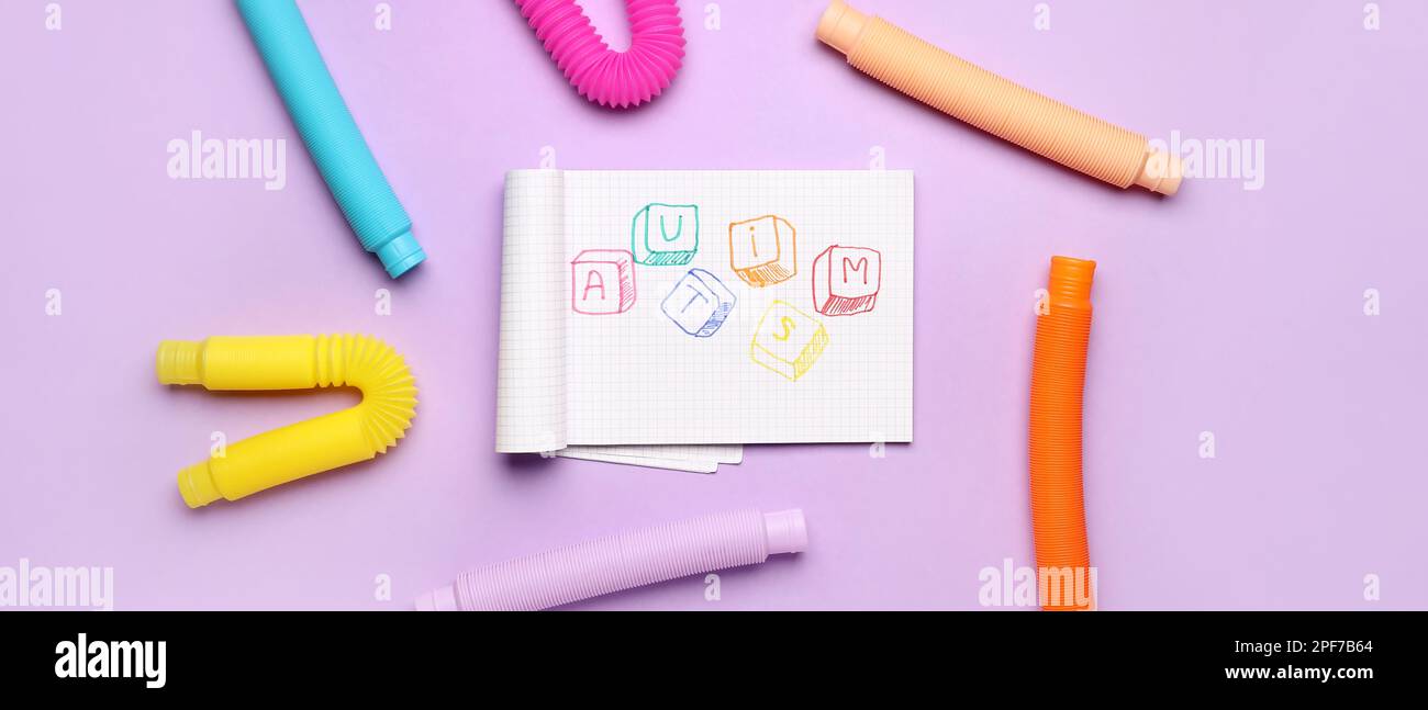 Notebook with word AUTISM and pop tubes on lilac background Stock Photo ...