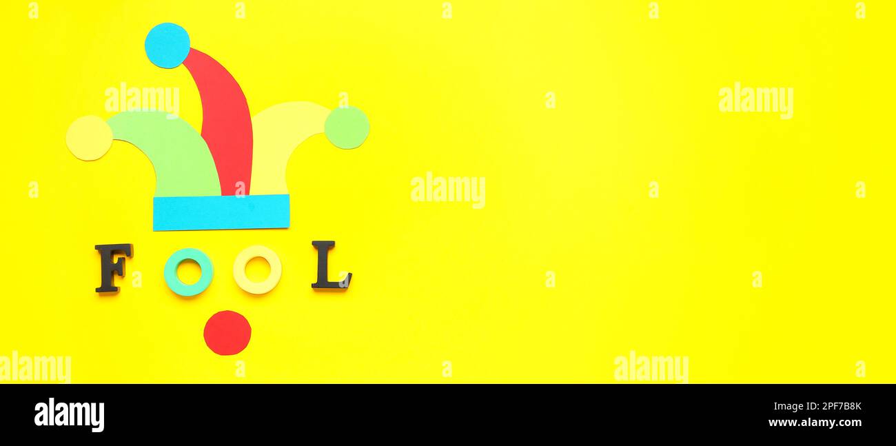 Paper hat and word FOOL on yellow background with space for text Stock ...
