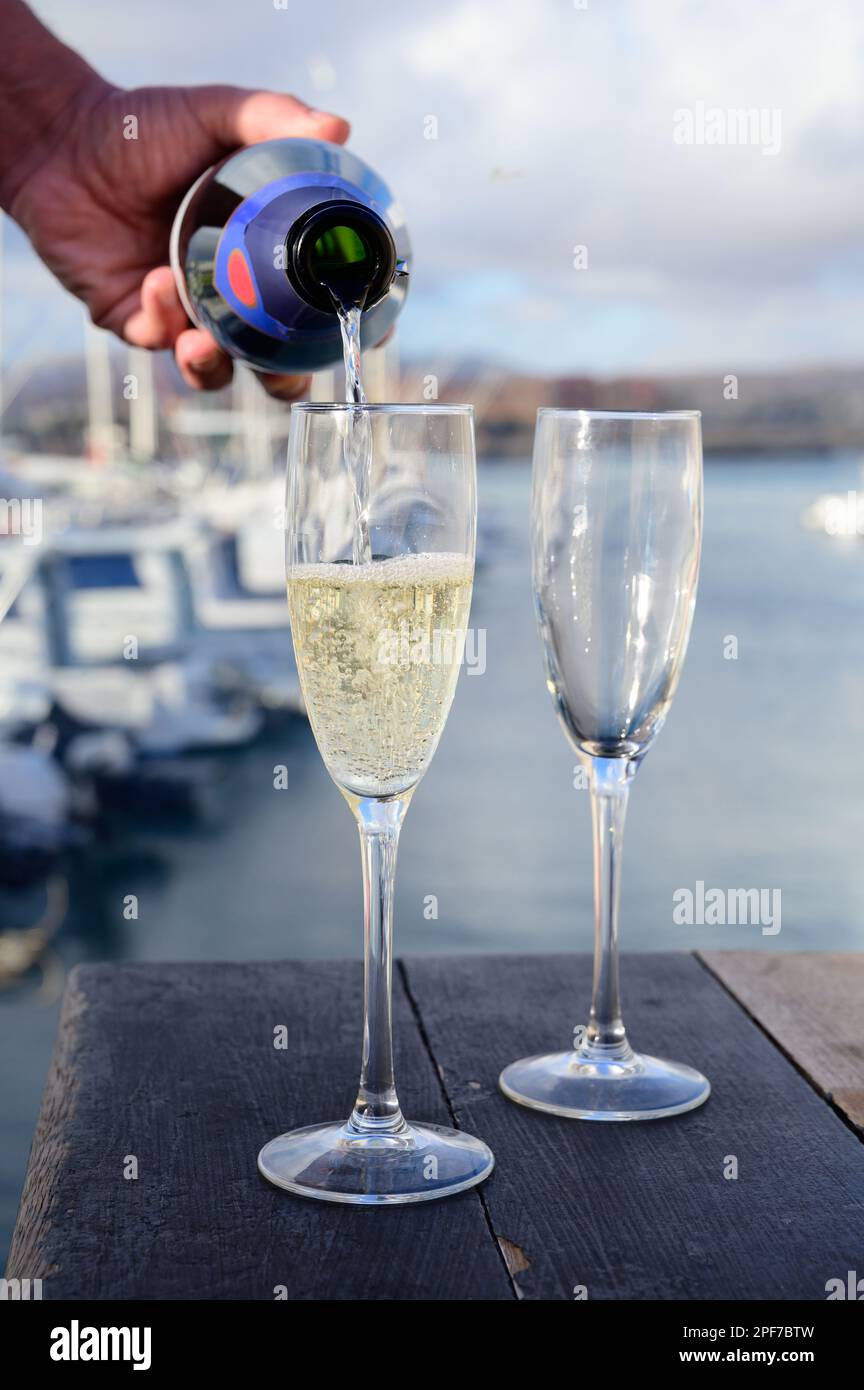Everyday party, pouring of cava or champagne sparkling wine in glasses ...