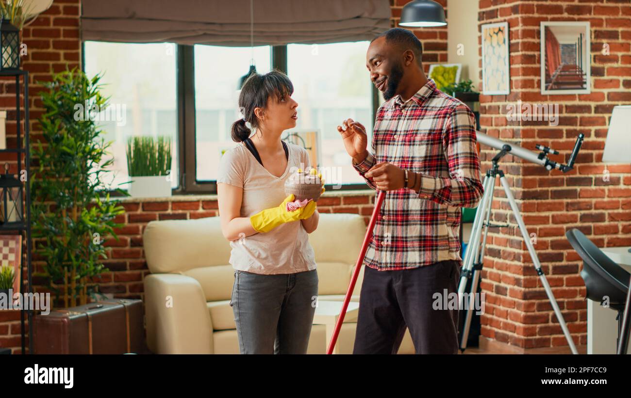 Interracial people cleaning household with tools and equipment, husband ...