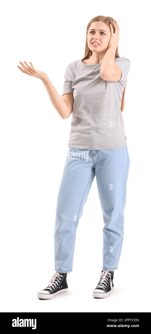 Irritated young woman suffering from loud noise on white background ...
