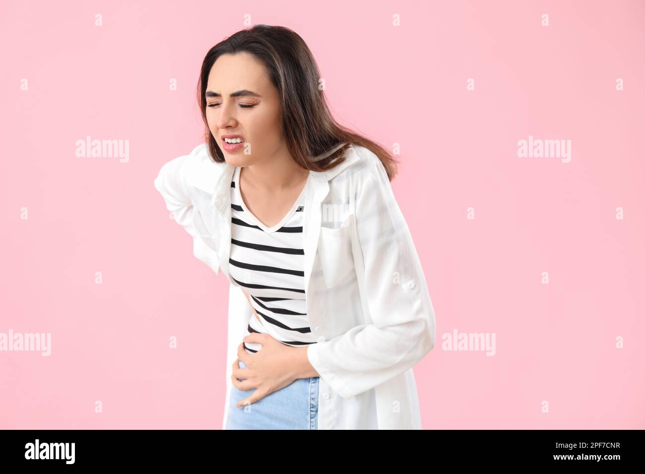 Young woman with appendicitis on pink background Stock Photo - Alamy