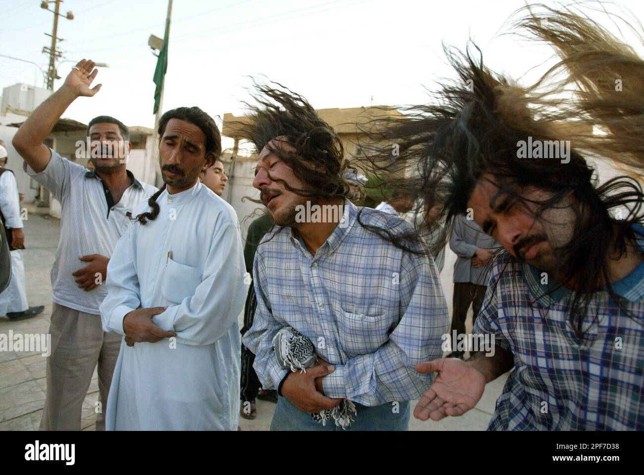 Iraqi men from the Kasnezania mystic order of Islam, some who twirl ...