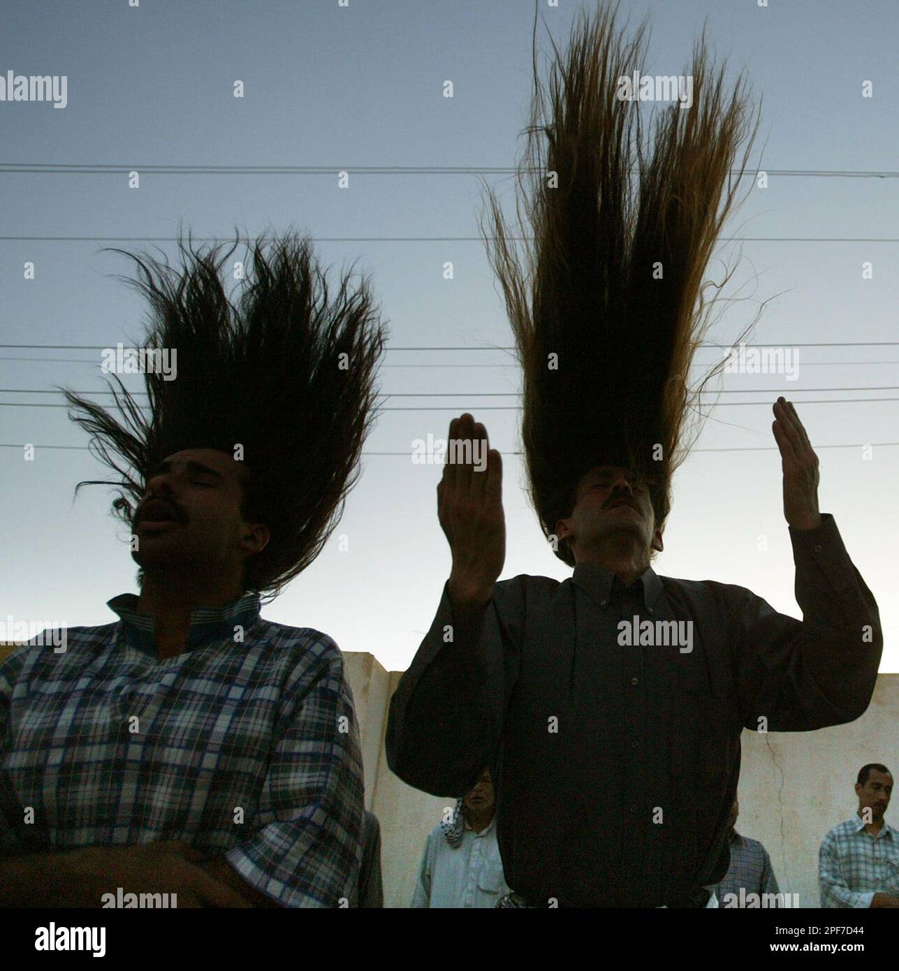 Iraqi men from the Kasnezania mystic order of Islam, some of whom twirl ...