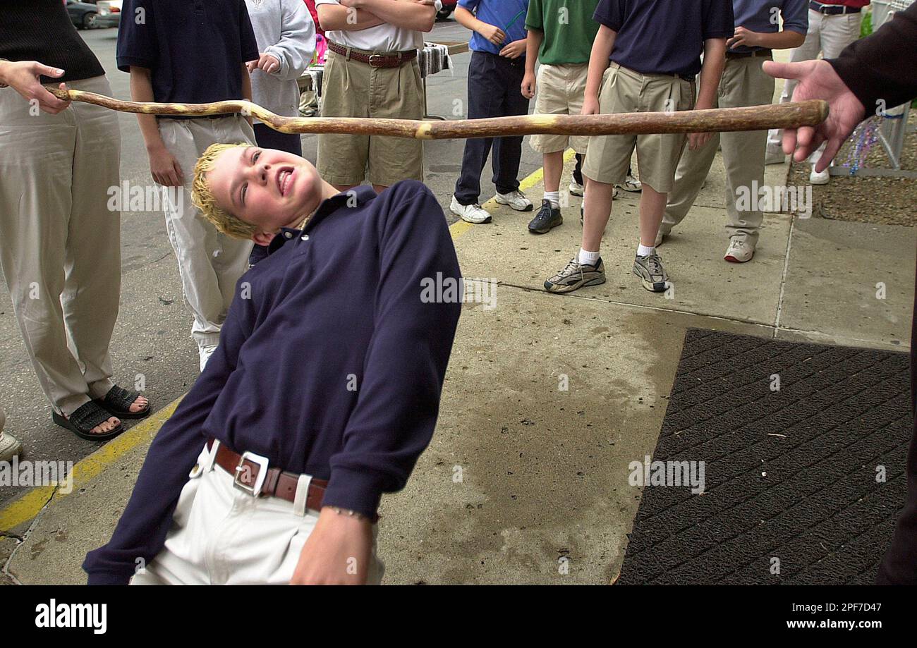 Ben Lakoff bends to navigate a limbo stick during the Cinco de mayo ...
