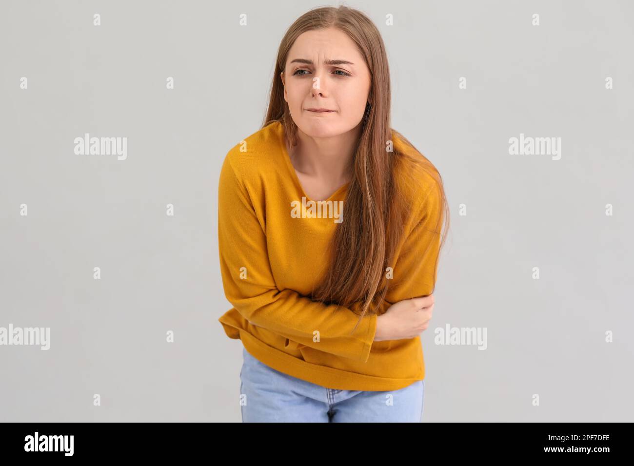 Young woman with appendicitis on grey background Stock Photo - Alamy