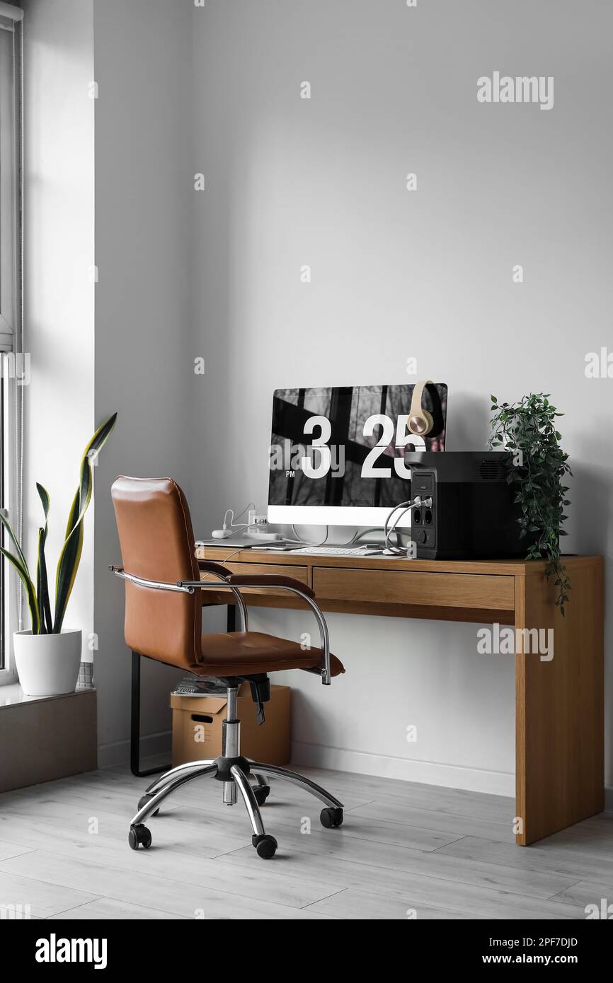 Workplace with computer and portable power station in office Stock ...