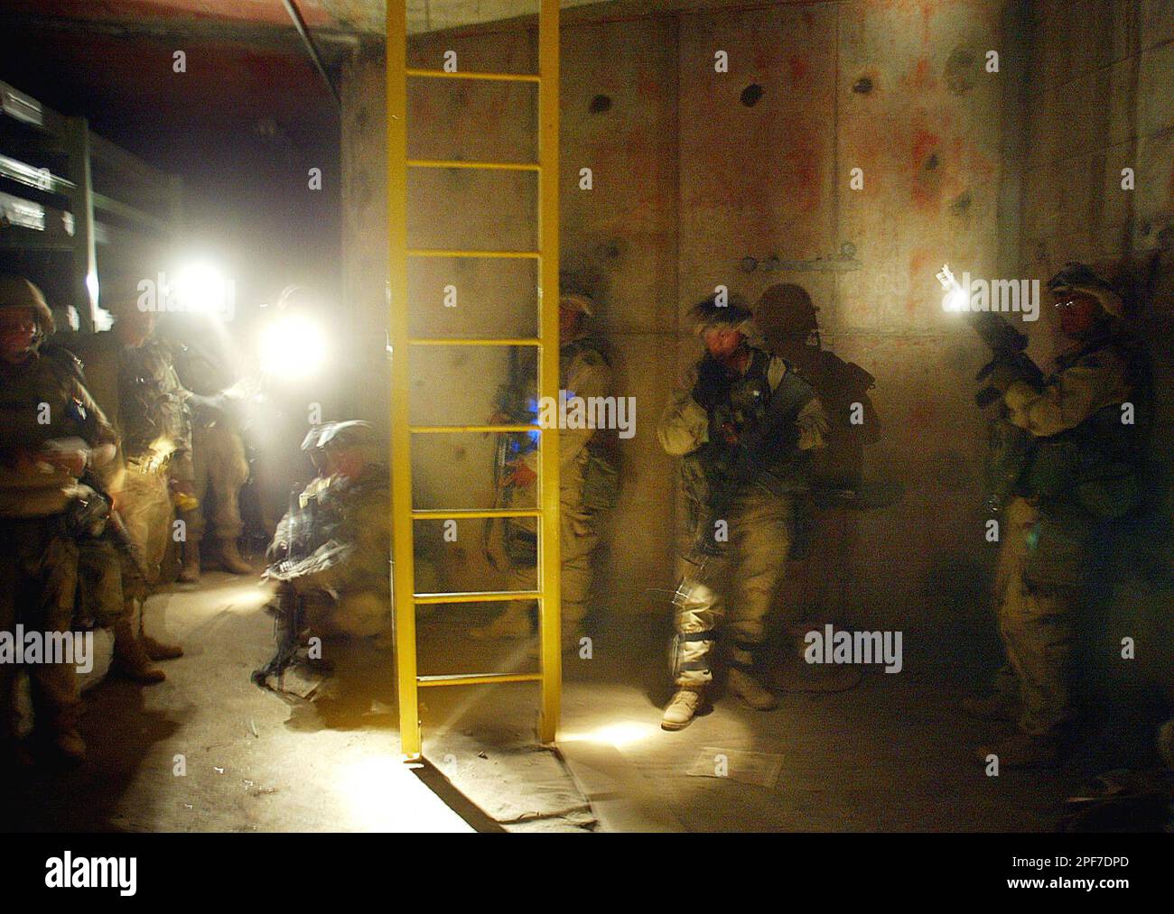 Soldiers of the 4th Infantry Division enter an underground oil refinery ...