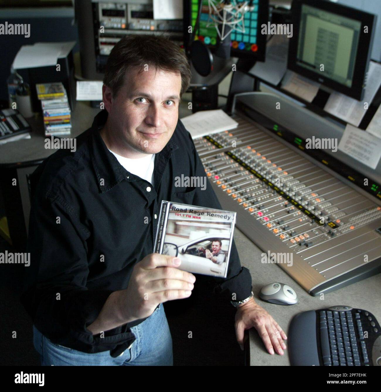 Disc jockey Christopher Hackett displays a "Road Rage Remedy" compact ...