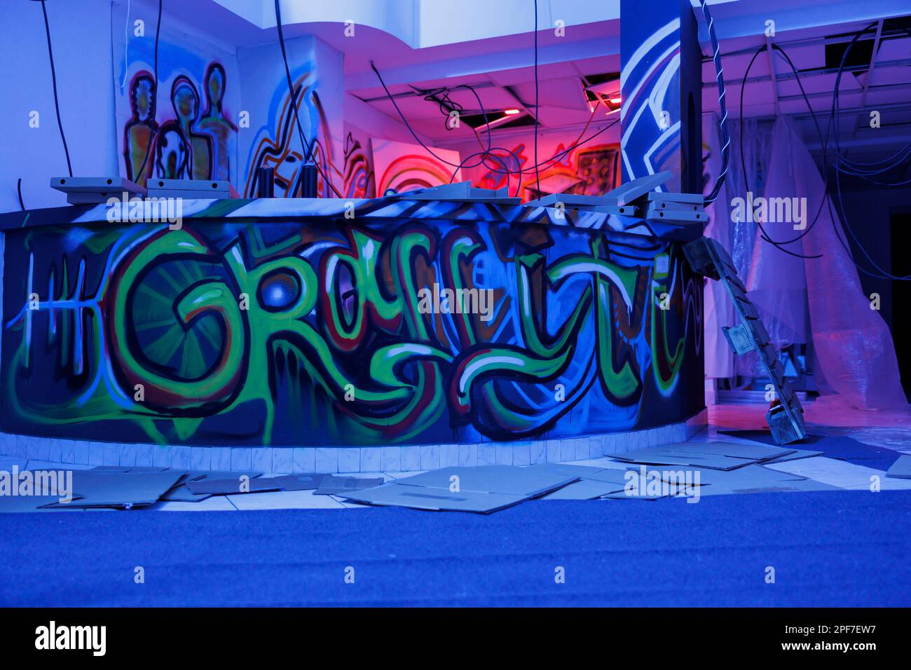 Rusty space with fluorescent lights crumbling down, graffiti spray ...