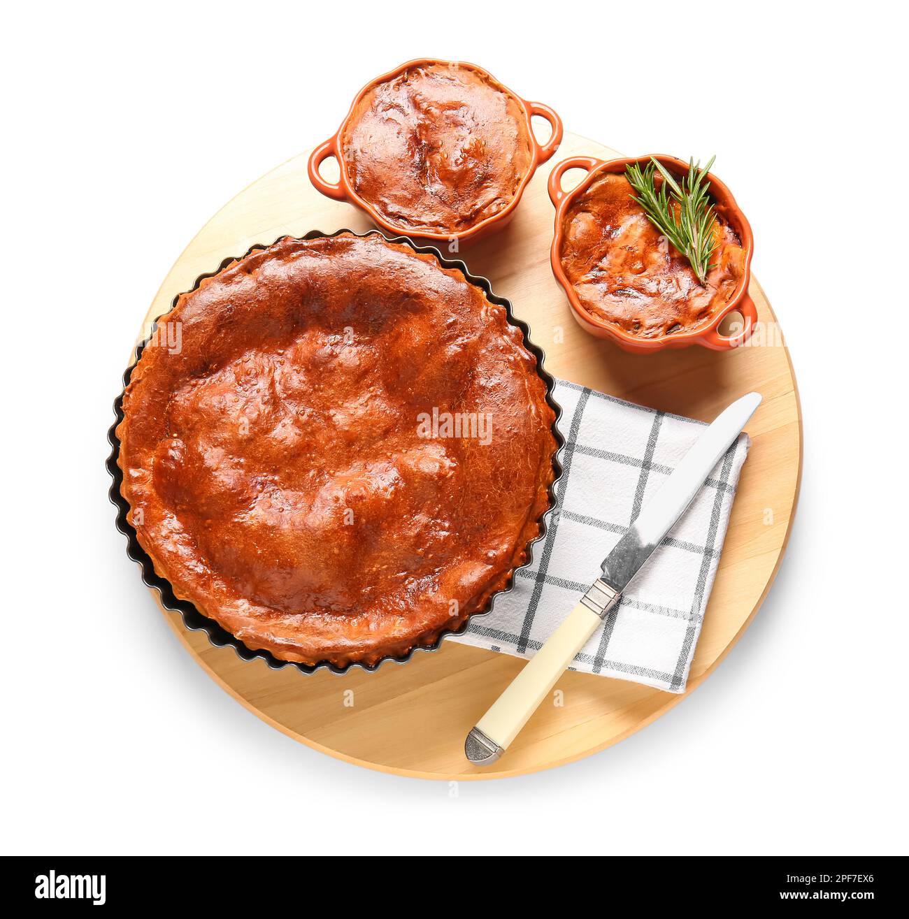 Board with delicious meat pies in baking forms isolated on white ...