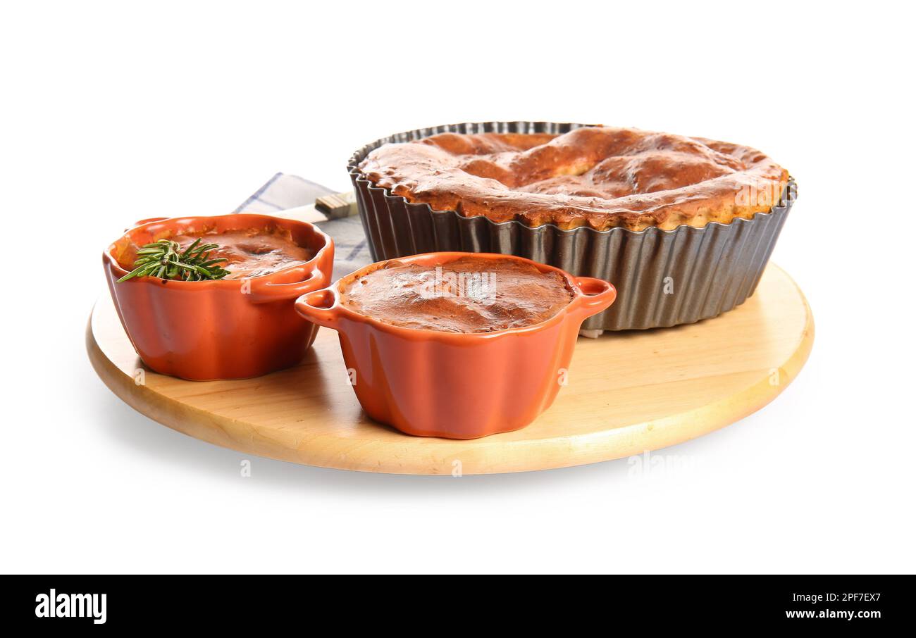 Board with delicious meat pies in baking forms isolated on white background Stock Photo - Alamy