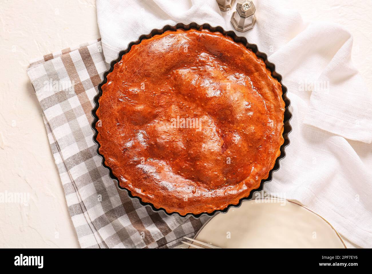Delicious meat pie in baking form on white grunge table Stock Photo - Alamy
