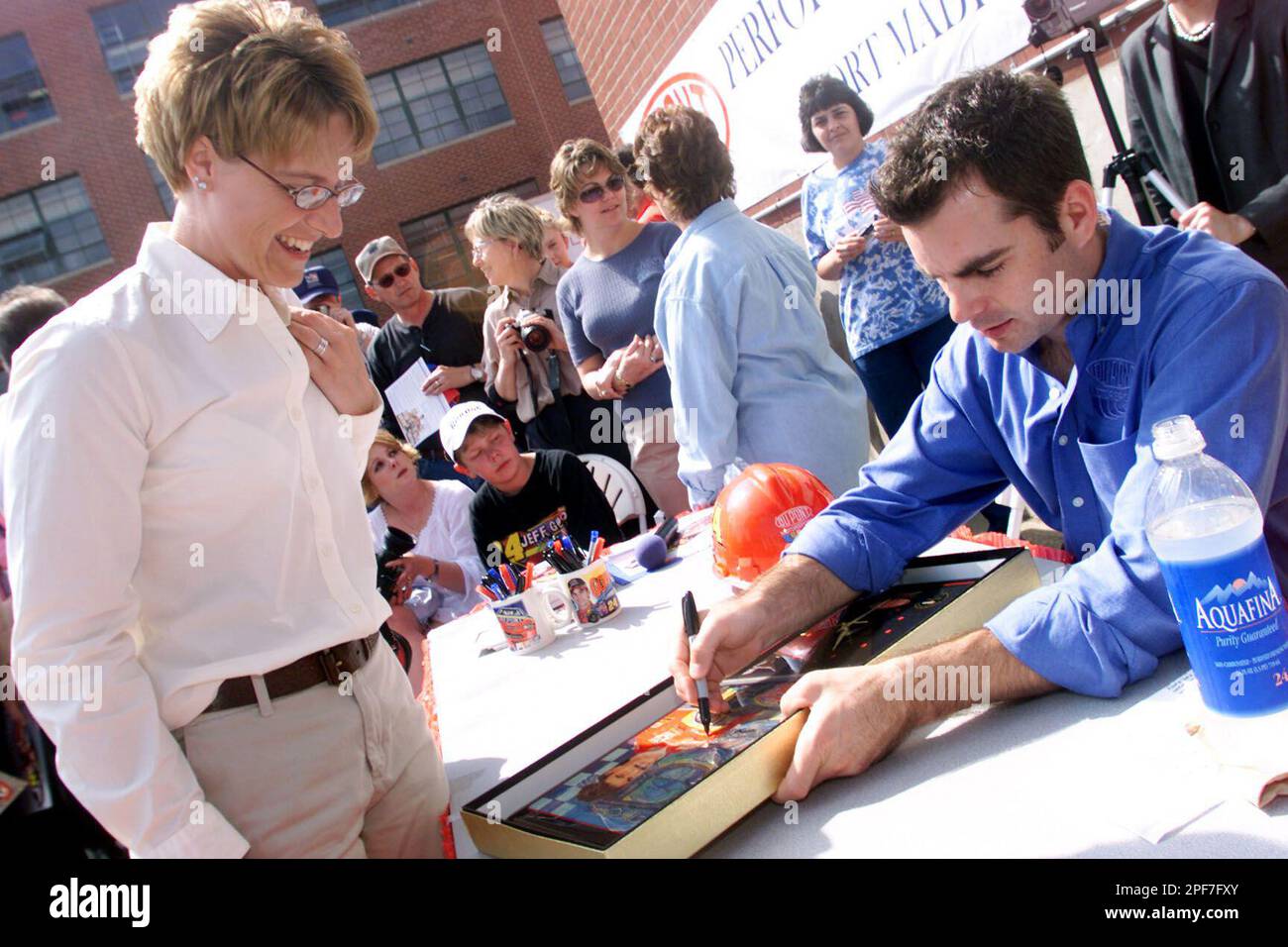 Four-time Winston Cup champion Jeff Gordon signs a clock for Aimee Noll ...