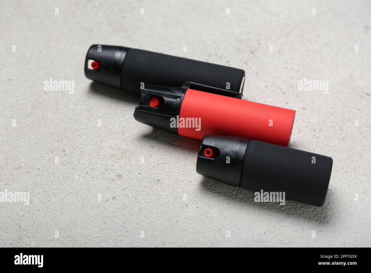 Pepper sprays on light background Stock Photo - Alamy