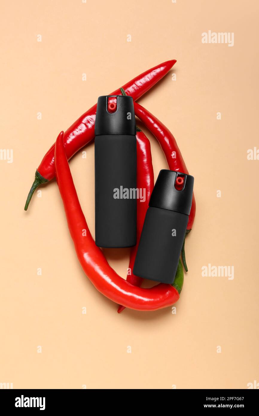 Sprays with chili peppers on beige background Stock Photo - Alamy