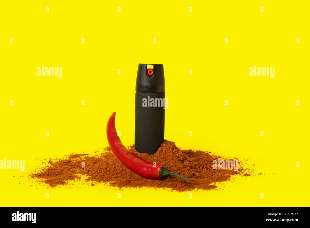 Spray with chili pepper and powder on yellow background Stock Photo - Alamy