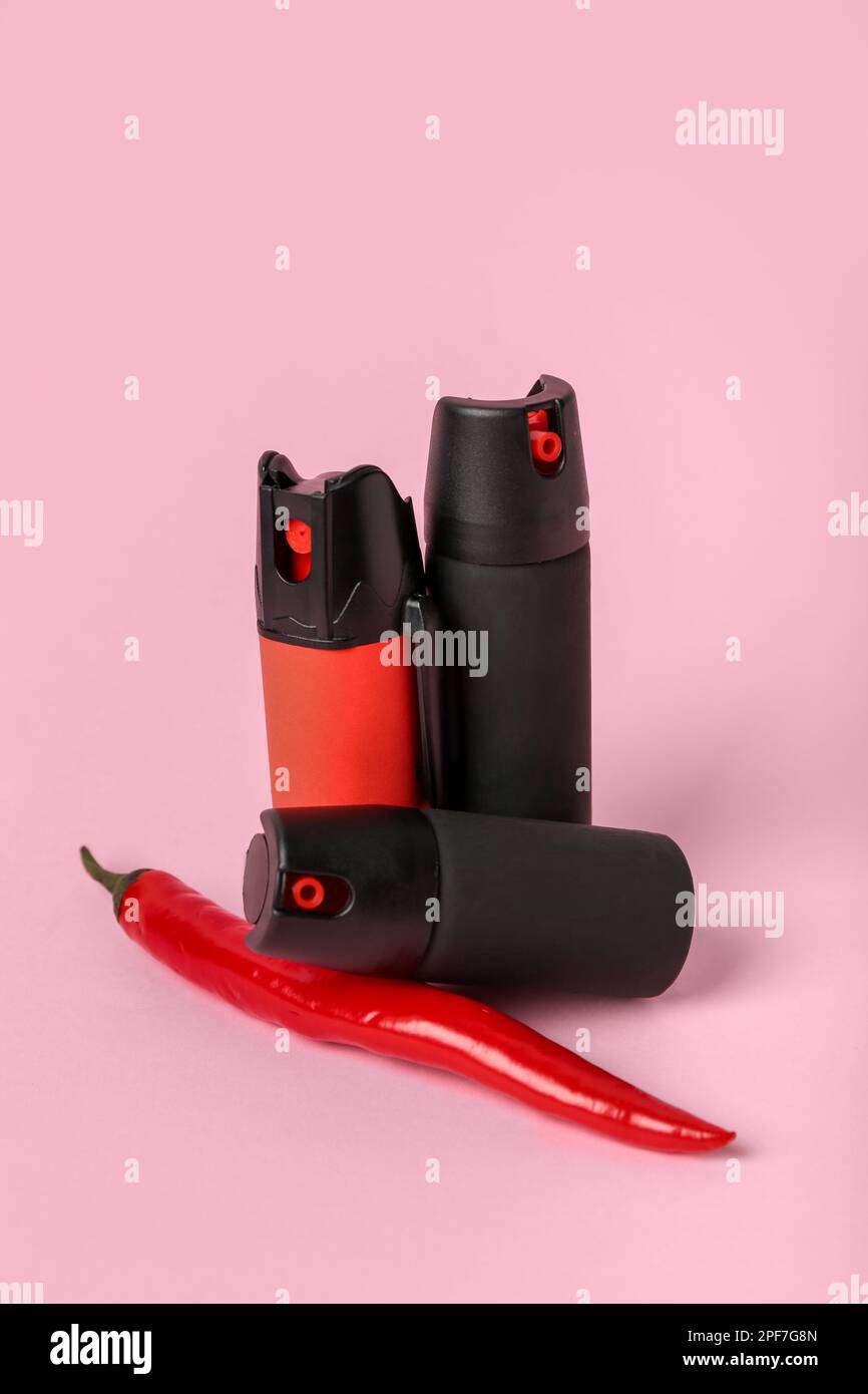 Sprays with chili pepper on pink background Stock Photo - Alamy