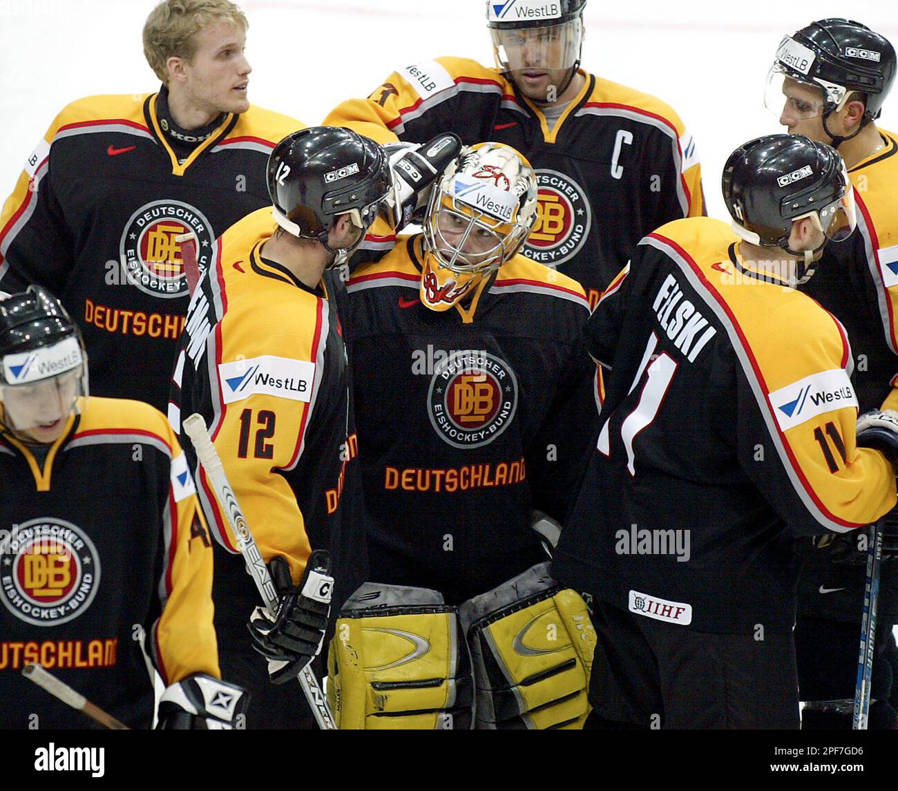 German hockey keeper Robert Mueller, center, is celebrated by the ...