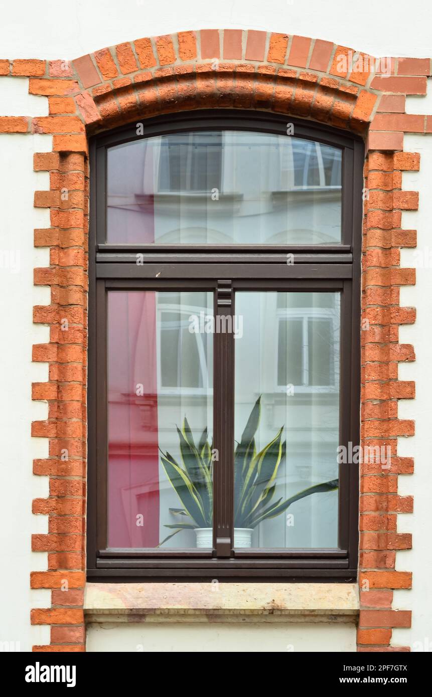 View of brick building with wooden window Stock Photo - Alamy