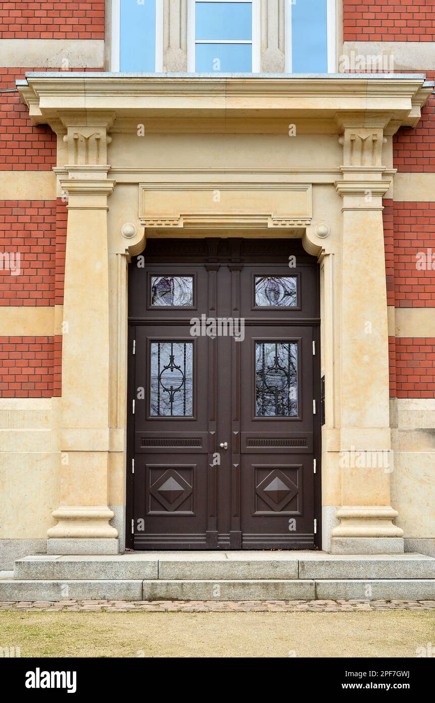 View of brick building with wooden door Stock Photo - Alamy