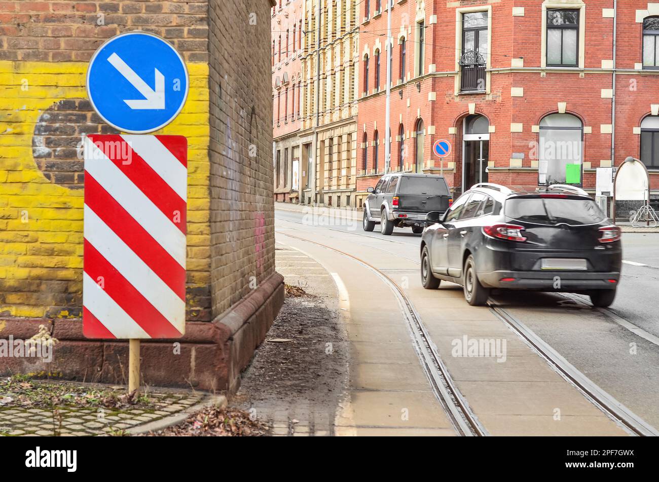 View of city street with warning road sign Stock Photo - Alamy