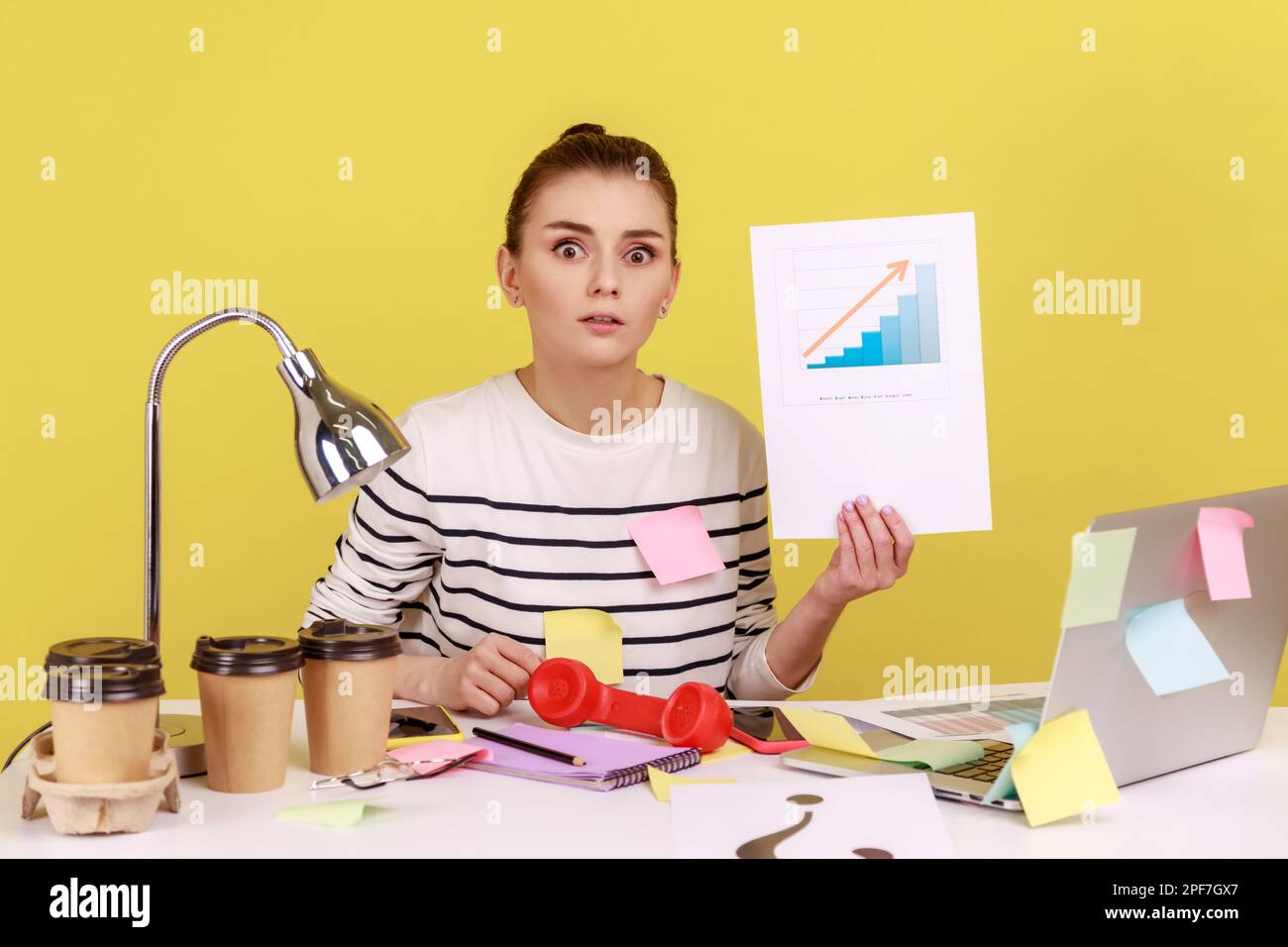 Portrait of serious woman office manager looking at camera showing ...