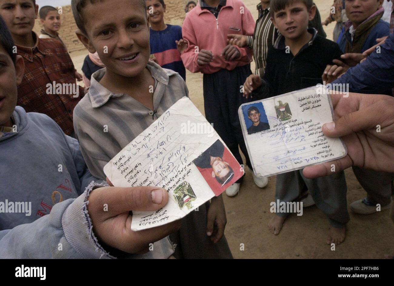 Iranian Kurd refugee students show off their Iraqi immigration identity ...