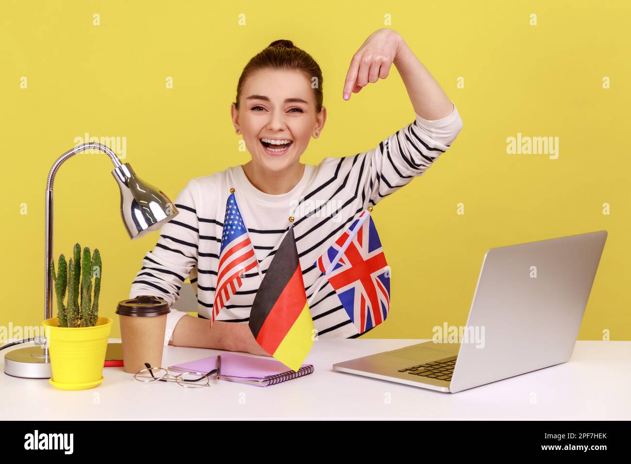 Excited happy woman pointing at flags of usa, german and great britain ...