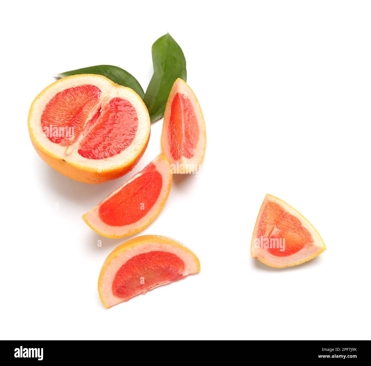 Pieces of ripe grapefruit and plant leaves on white background Stock ...