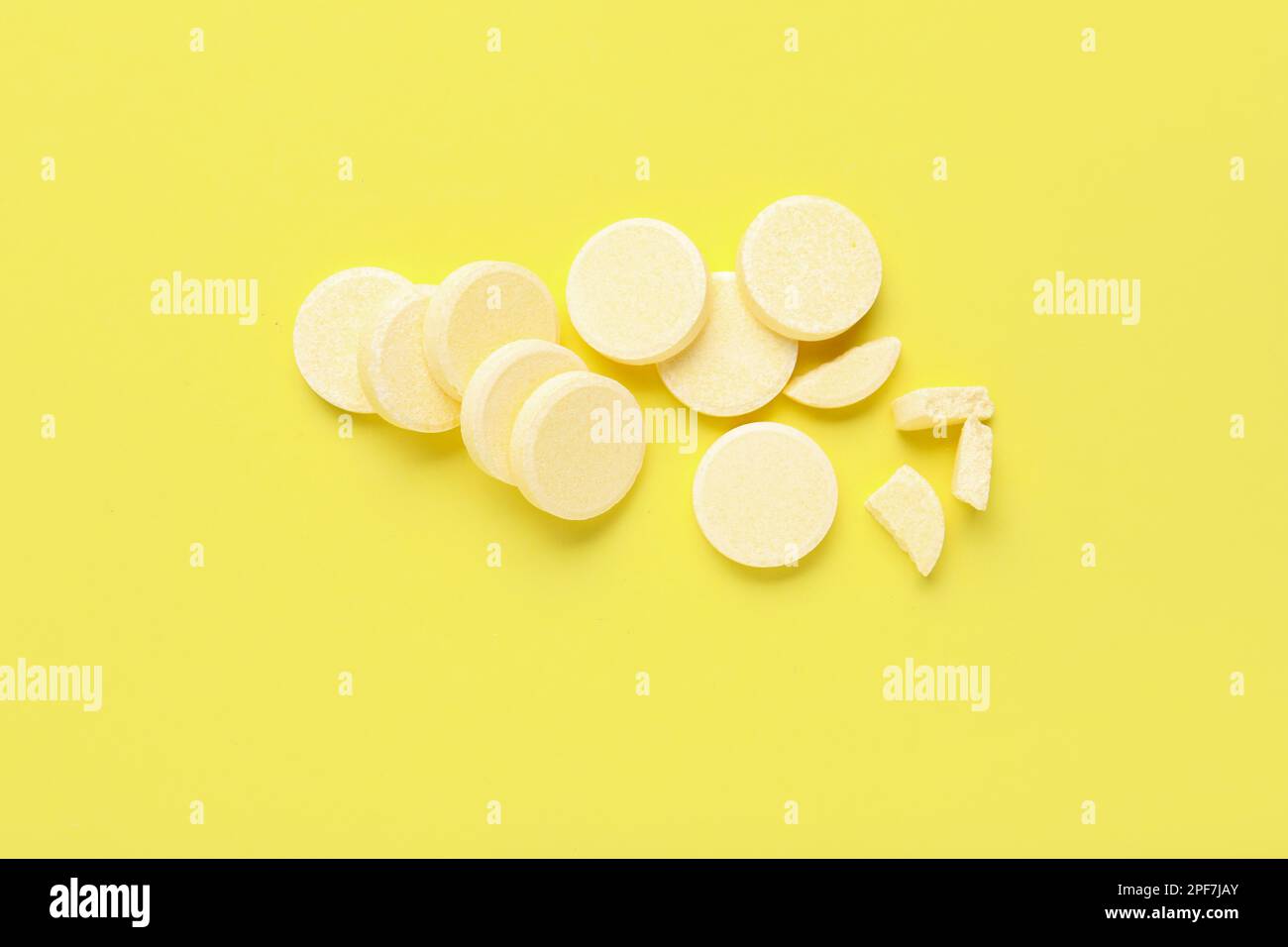 Soluble tablets on yellow background Stock Photo - Alamy