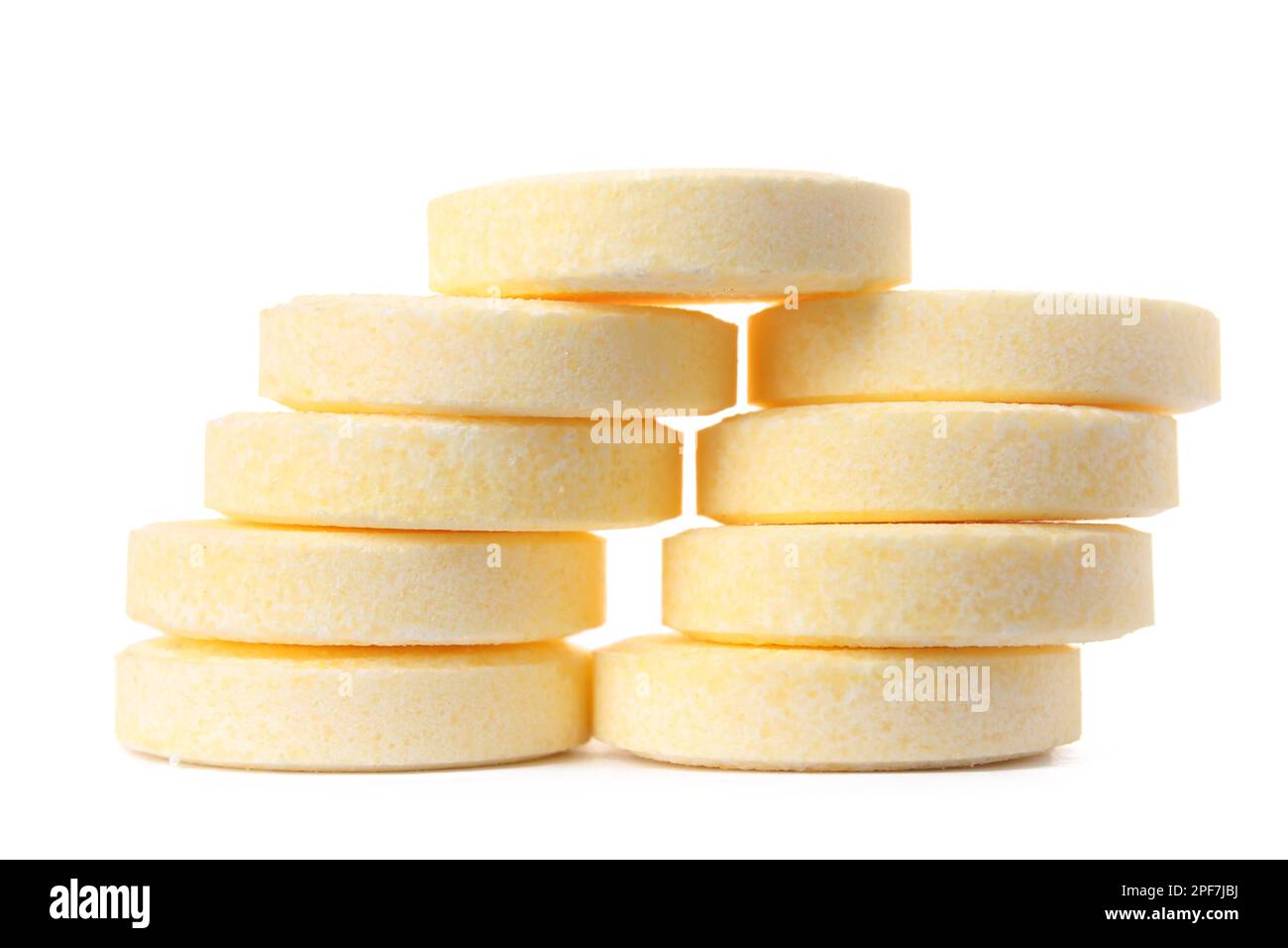 Stacks of yellow soluble tablets isolated on white background Stock ...