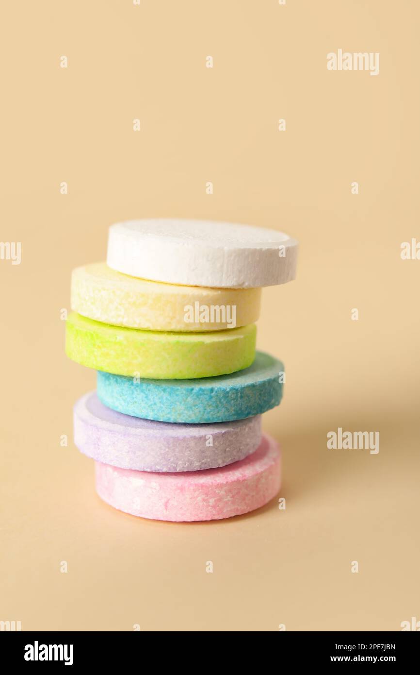 Stacks of colorful soluble tablets on beige background Stock Photo - Alamy
