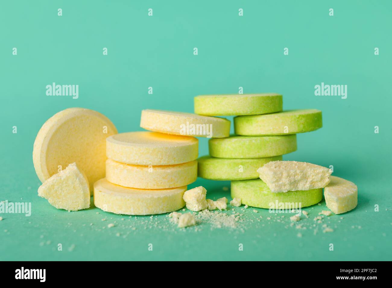 Yellow and green soluble tablets on turquoise background Stock Photo ...