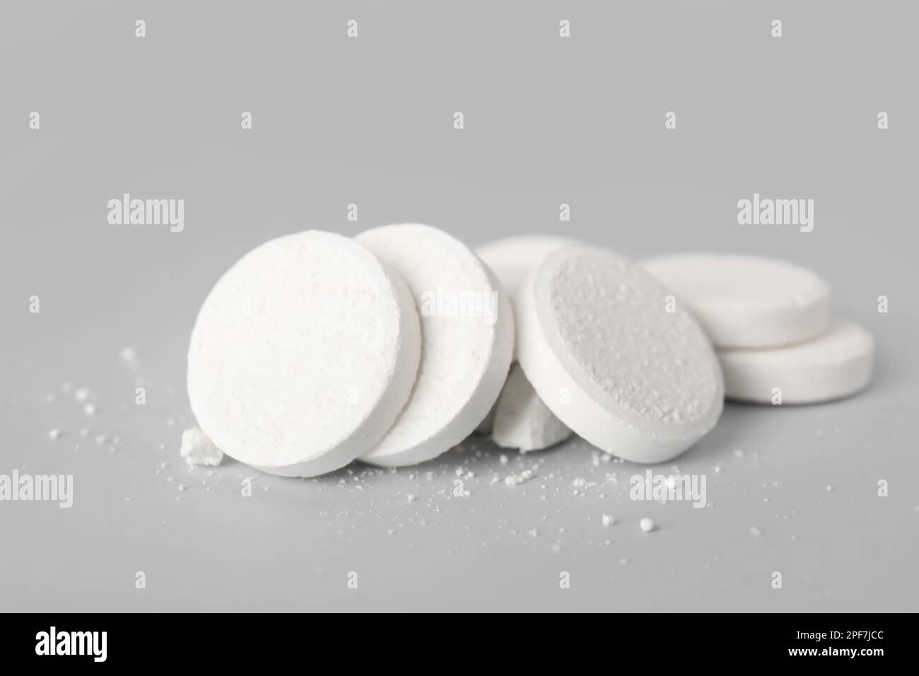 White soluble tablets on grey background Stock Photo - Alamy