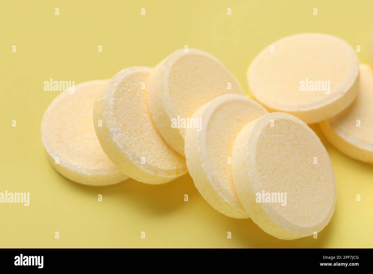 Soluble tablets on yellow background Stock Photo - Alamy