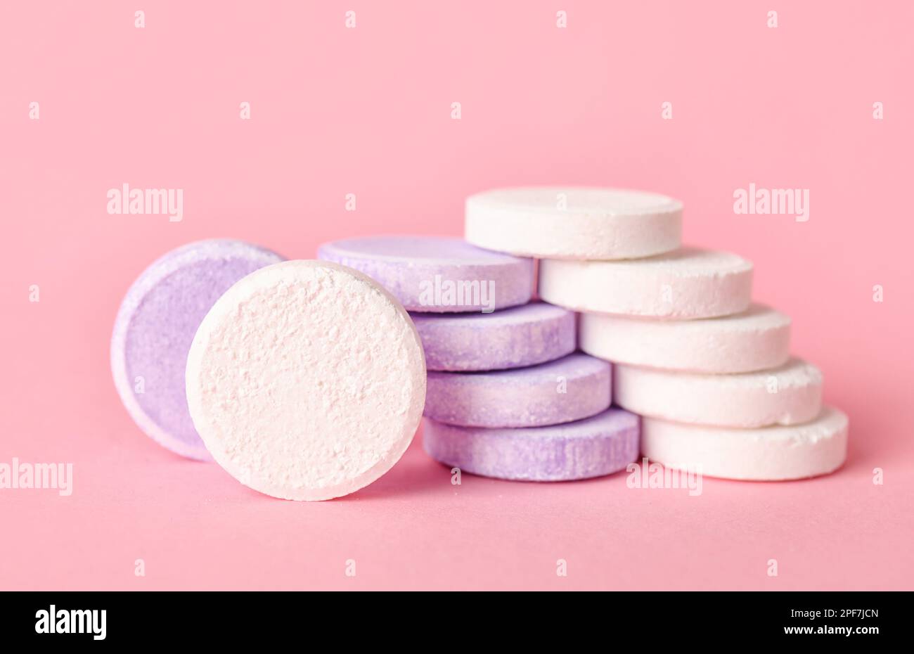White and lilac soluble tablets on pink background Stock Photo - Alamy