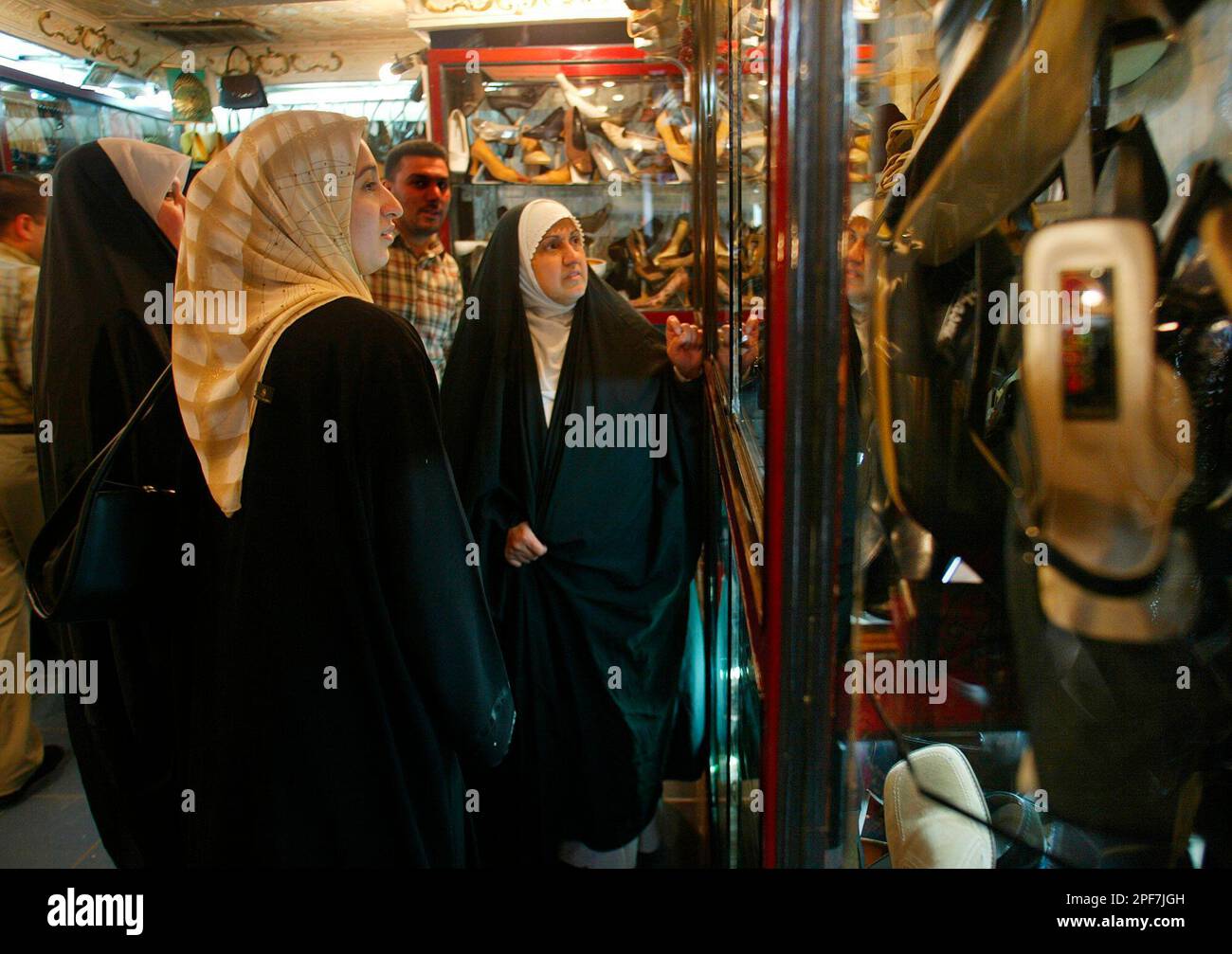 Iraqi women look for shoes as shops start reopening in Mosul, Iraq ...